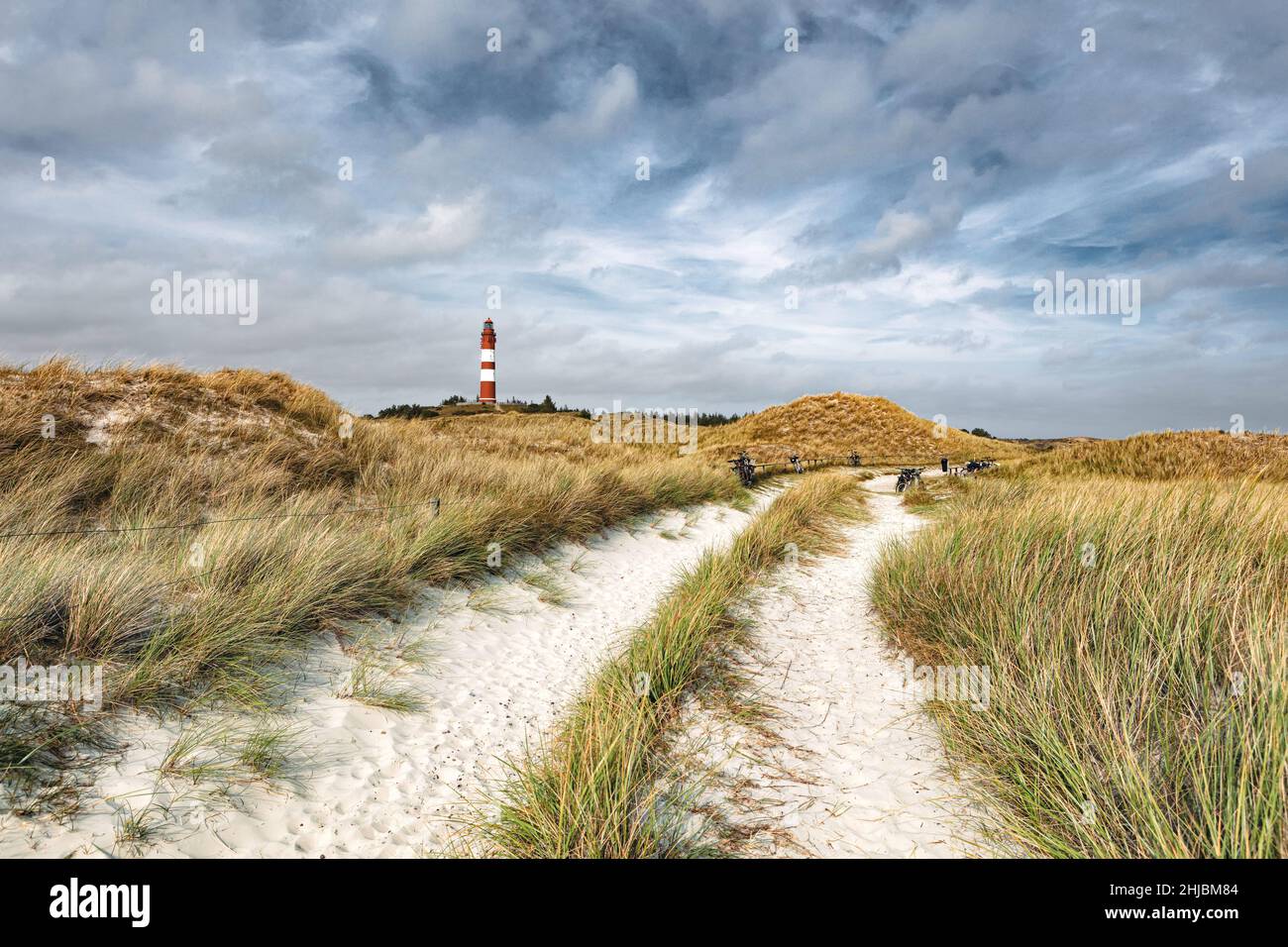 Sandy dirt road through coastal landscape. Bicycles standing at bike ...