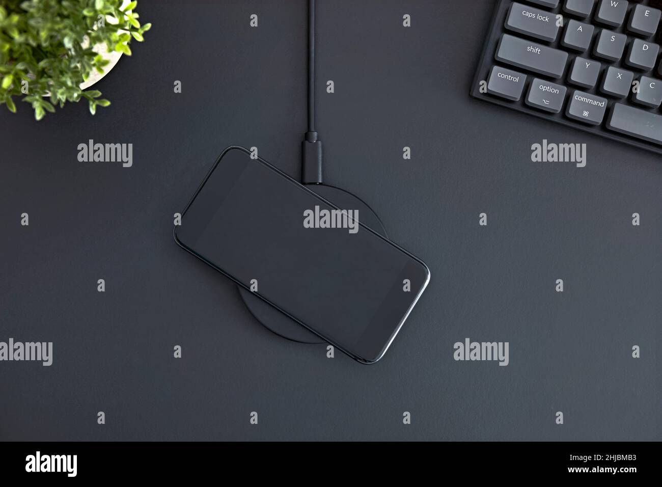 Usage of wireless charger in office. Recharging smartphone battery ...