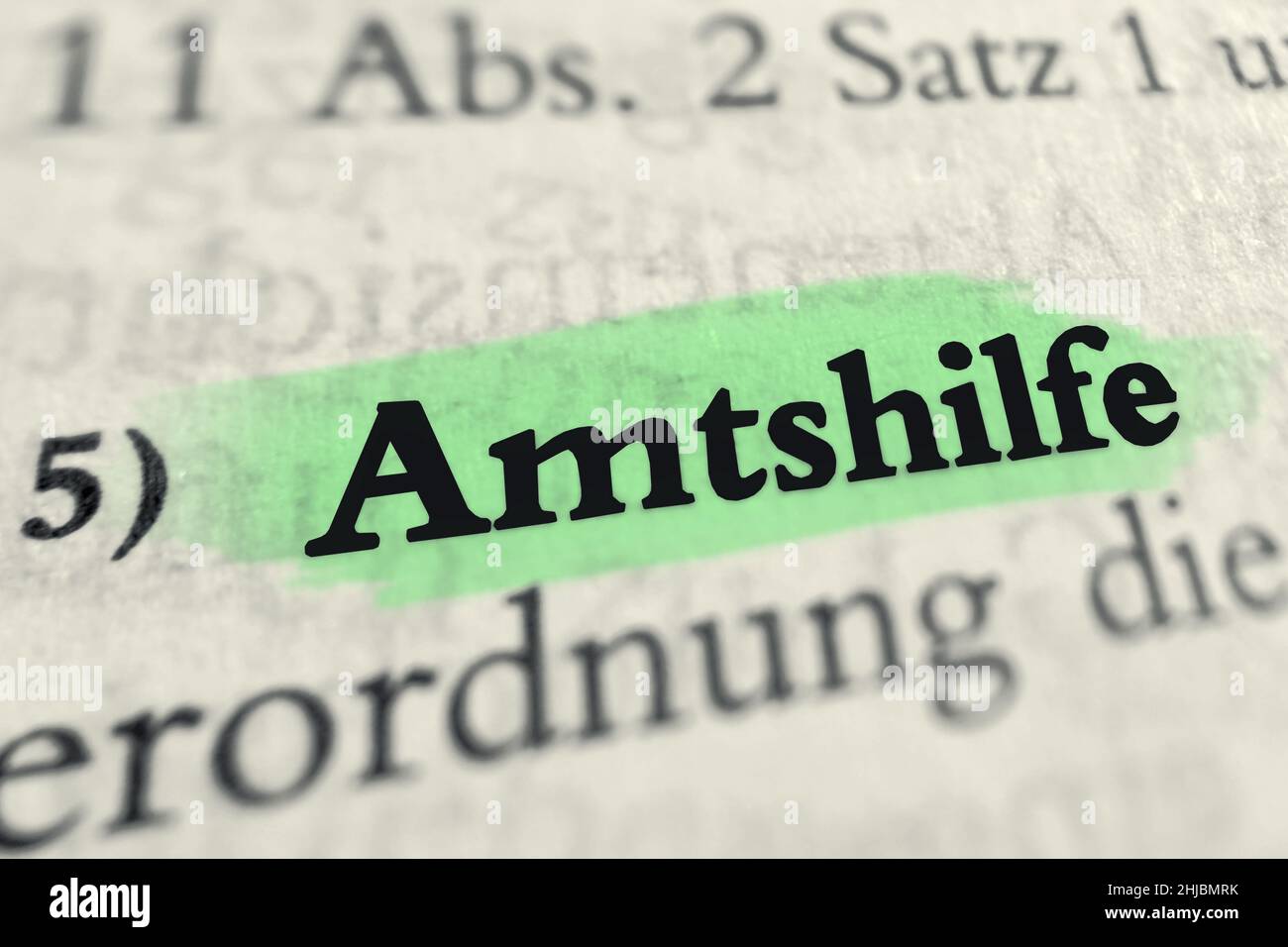 Closeup on the highlighted German word "Amtshilfe" in a newspaper Stock ...