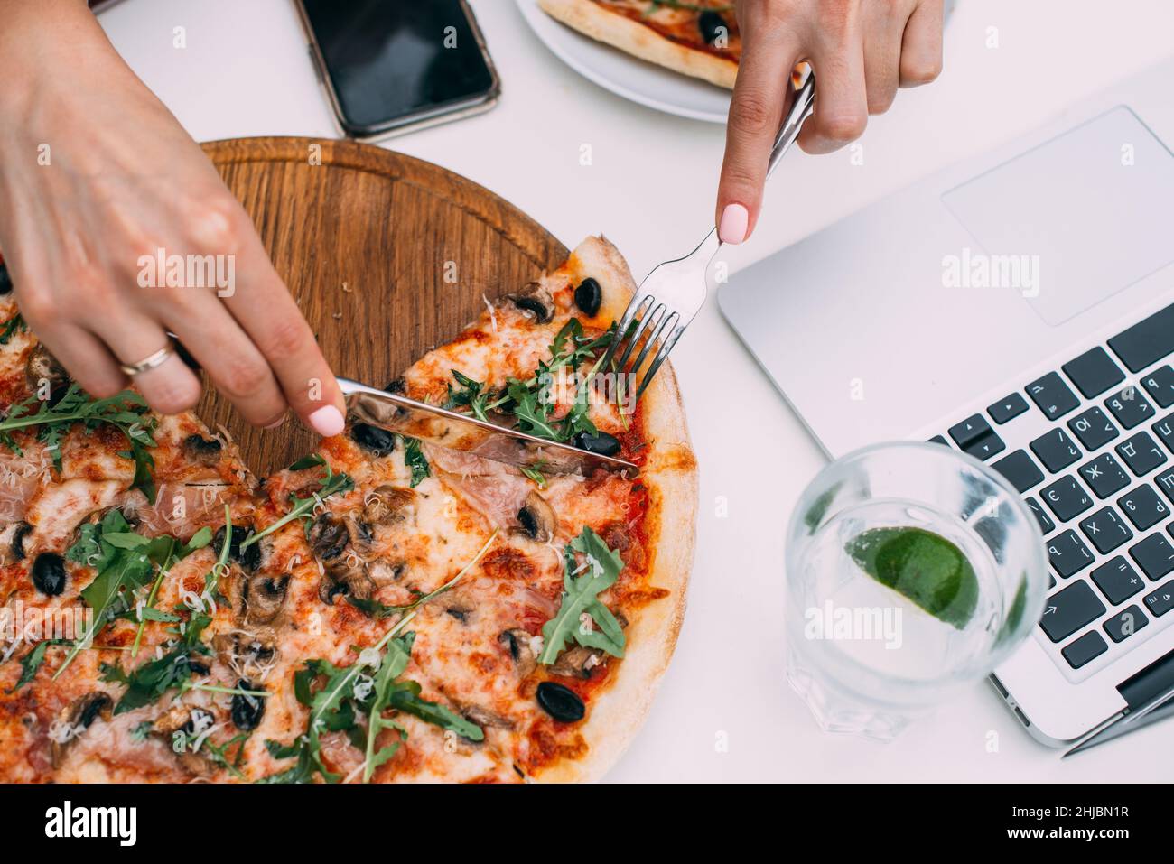 Top view of business woman working on a table at a pizza restaurant ...