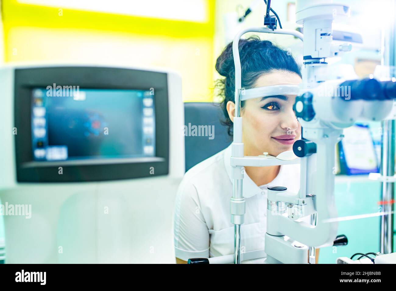 arabian patient checking eyesight and vision correction in optometrist ...