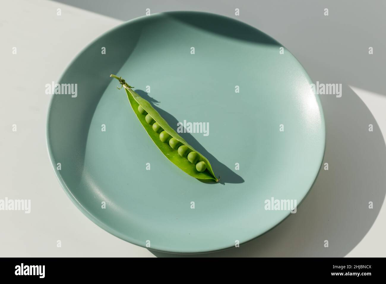 One green pea on the green plate. Healthy lifestyle concept Stock Photo ...