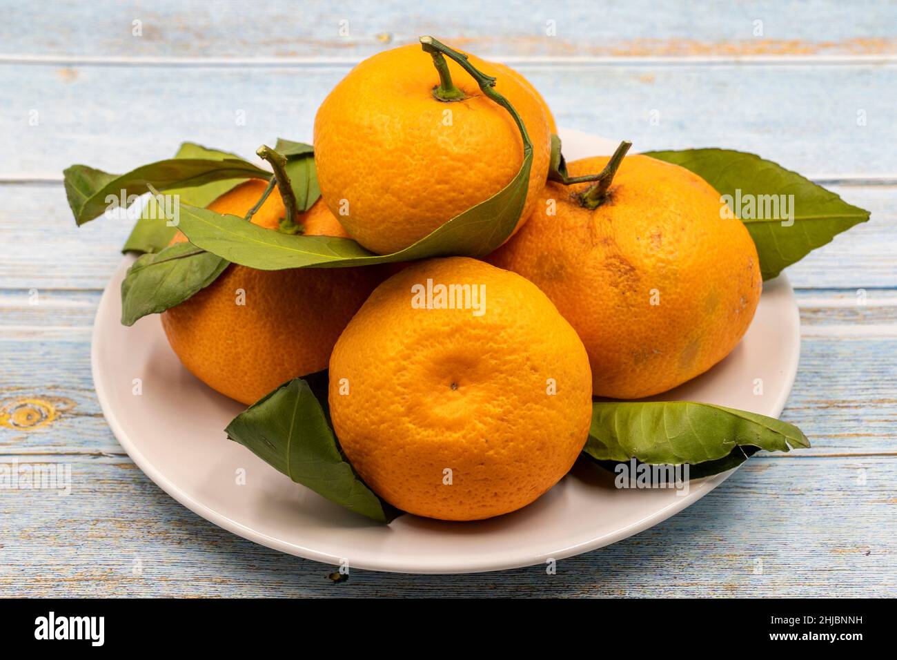 Tangerine on blue background. close up Stock Photo - Alamy