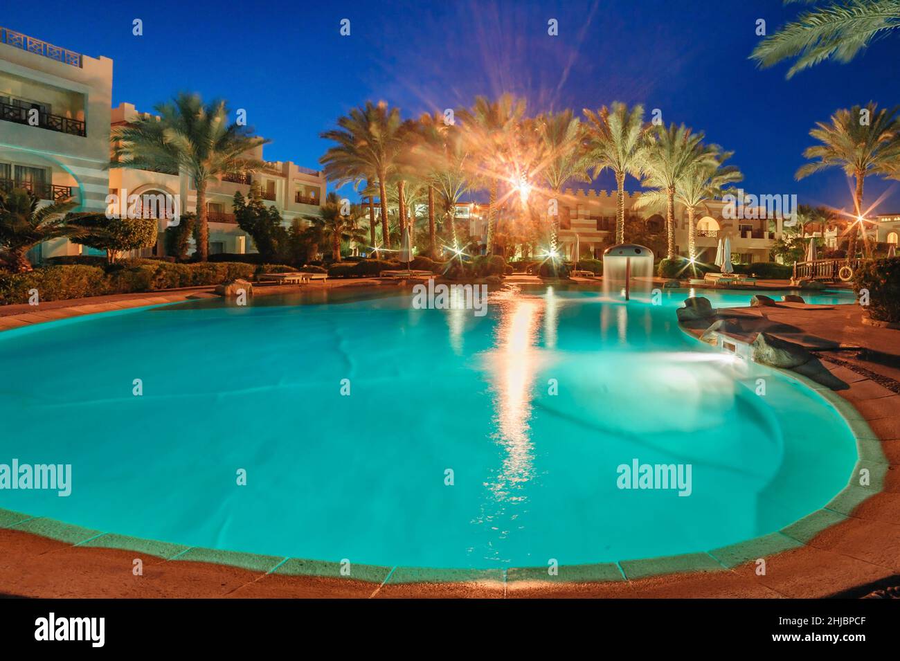 Night view of Beautiful swimming pool and palm trees in Egypt Stock ...