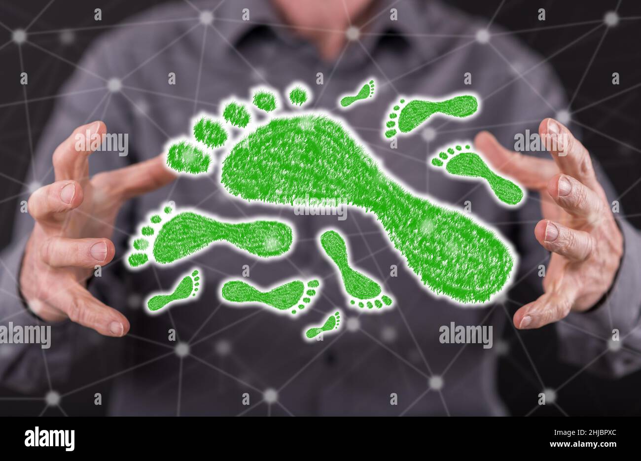 Carbon footprint concept between hands of a man in background Stock ...