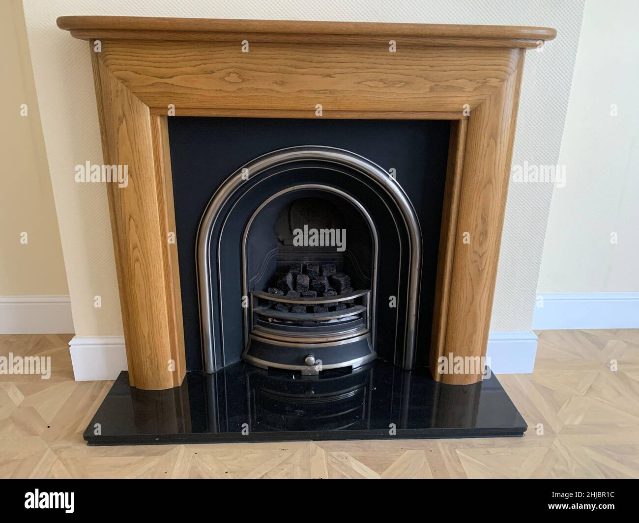 Wood fireplace surround Stock Photo - Alamy