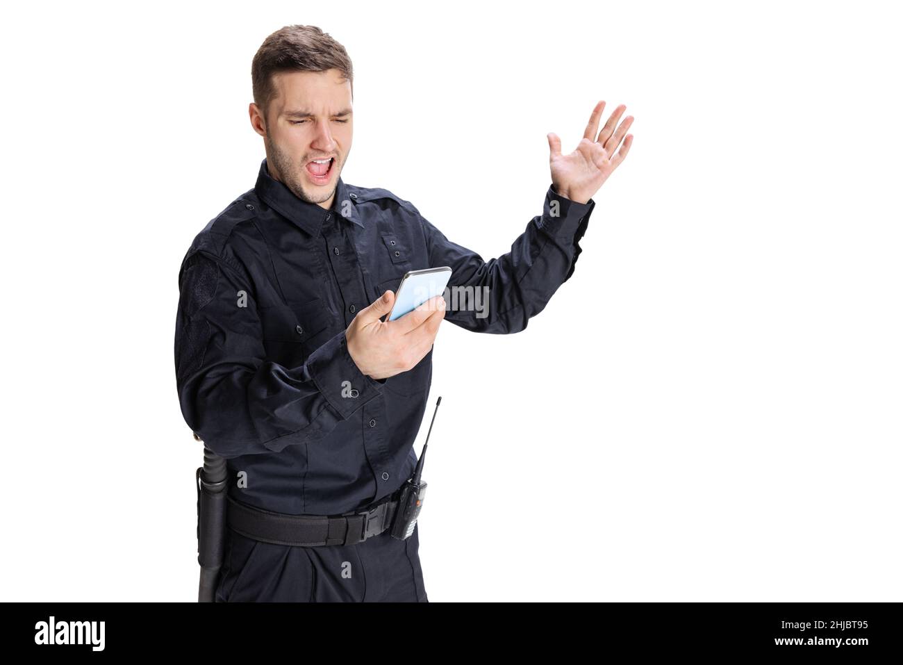 Portrait of young excited man, policeman officer wearing black uniform ...