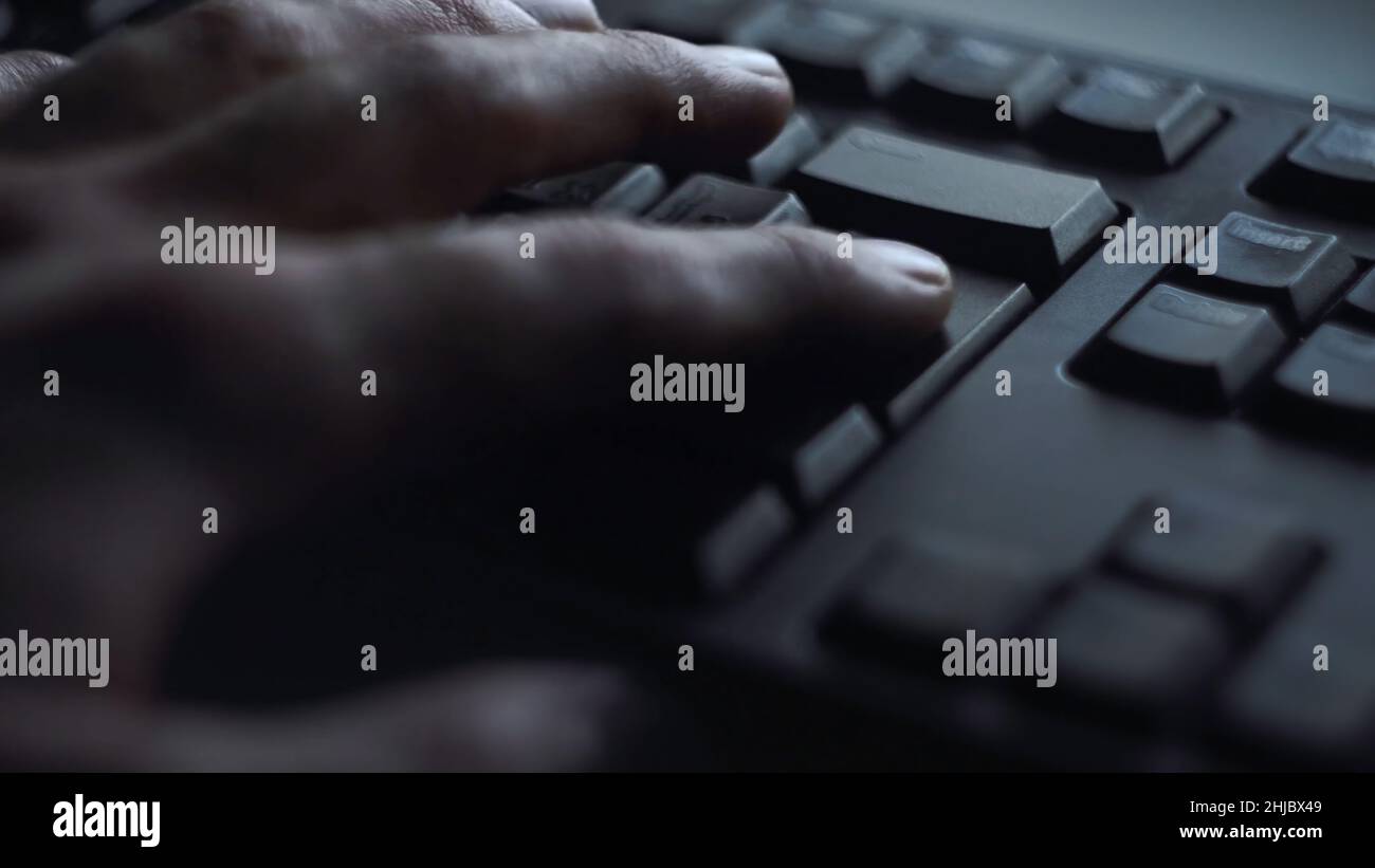Close-up man presses keyboard key. Man presses button enter computer ...