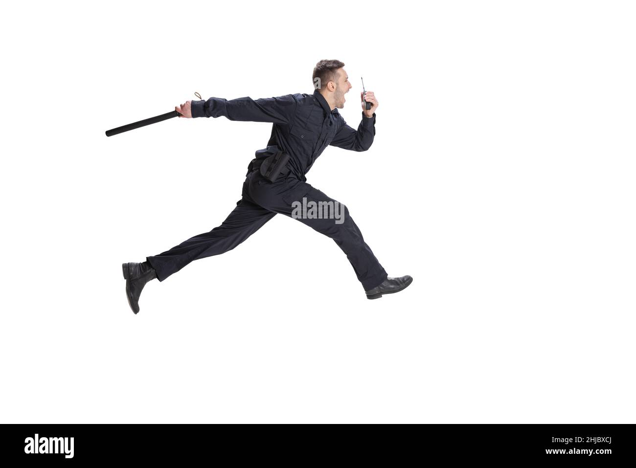 Dynamic portrait of young man, policeman officer wearing black uniform ...