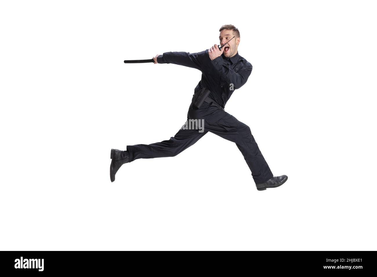 Dynamic portrait of young man, policeman officer wearing black uniform ...