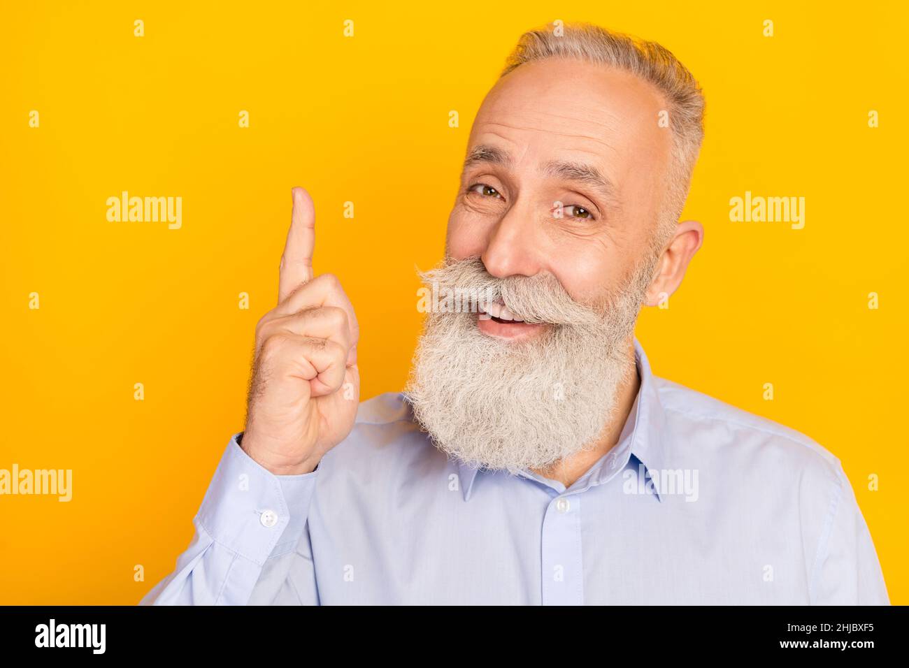 Photo of happy retired grey haired positive old man point finger up ...
