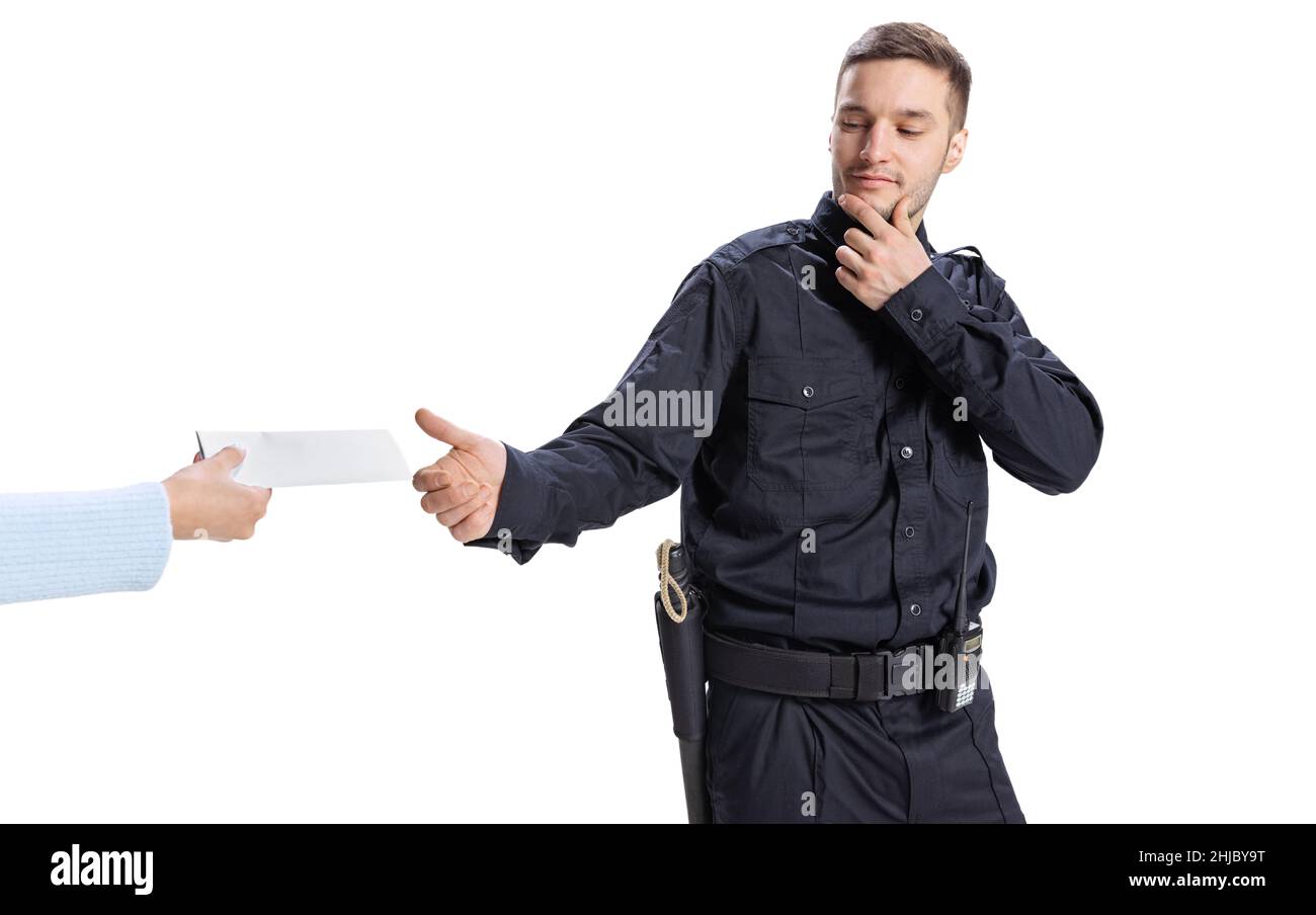 Portrait of young man, policeman wearing black uniform refuses a bribe ...