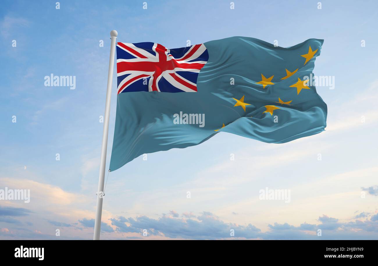 official flag of Tuvalu at cloudy sky background on sunset, panoramic ...