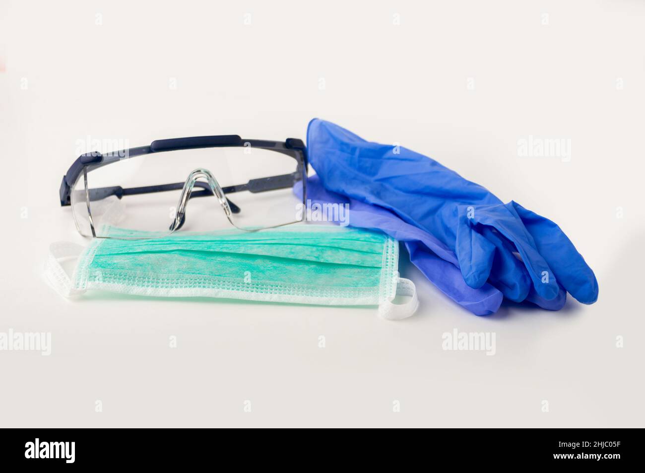Shot of a mask ,glove and goggles lying on top of a white table Stock ...