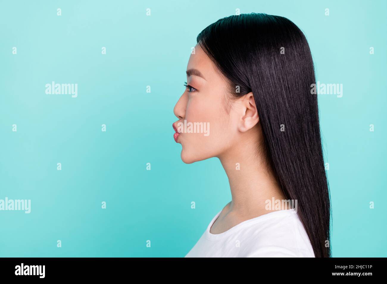 Profile side view portrait of attractive long-haired girl sending air ...
