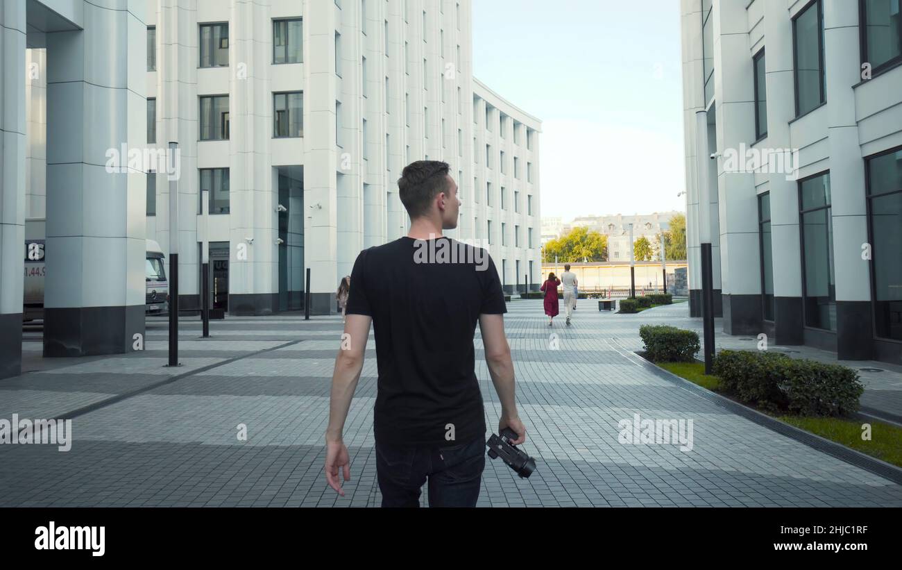 Photographer takes pictures of city's modern architecture. Action ...