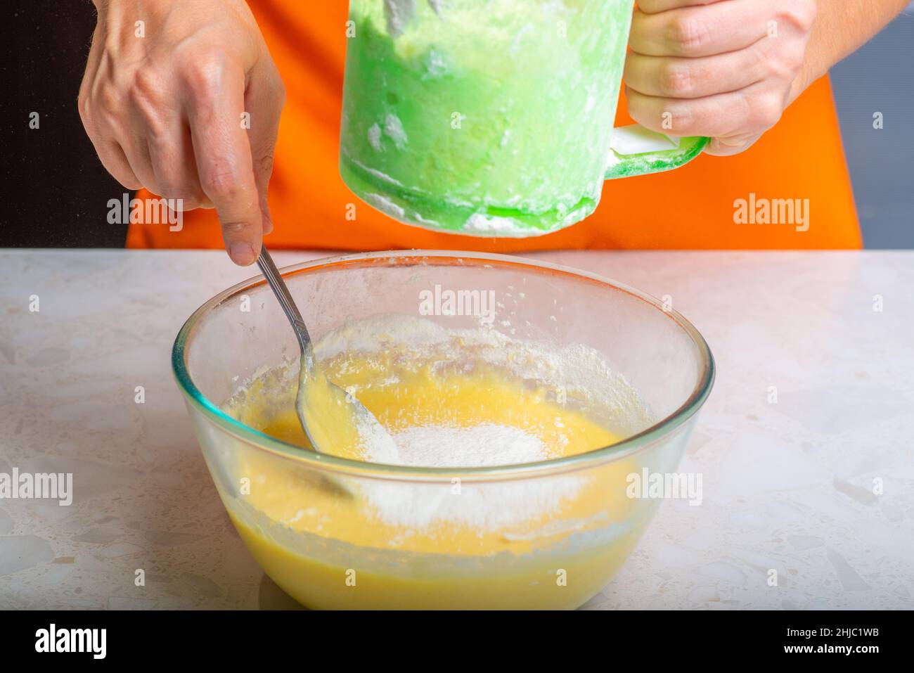 pour flour into a cup with ingredients Stock Photo - Alamy