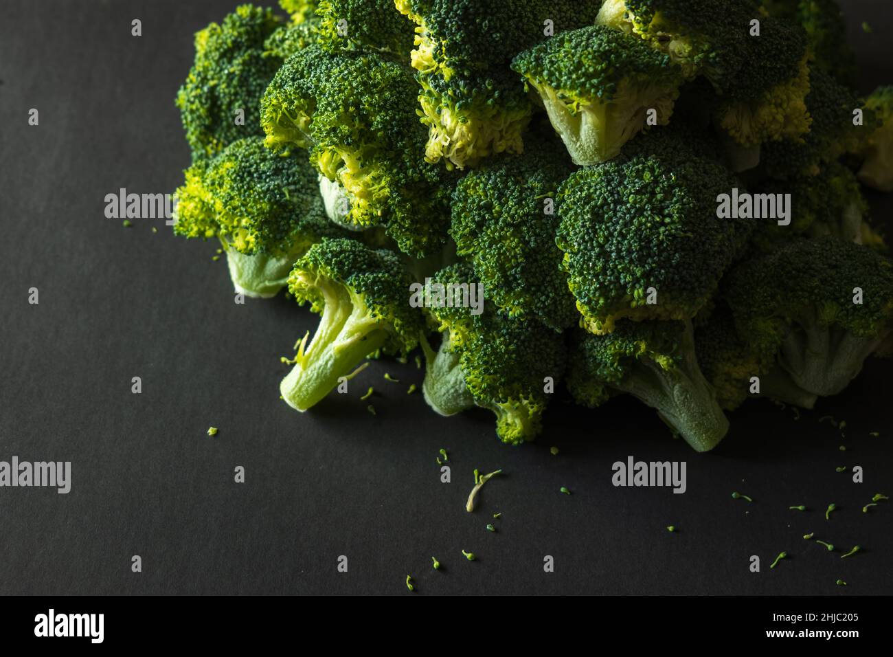 Frozen green broccoli florets on dark background closup Stock Photo - Alamy