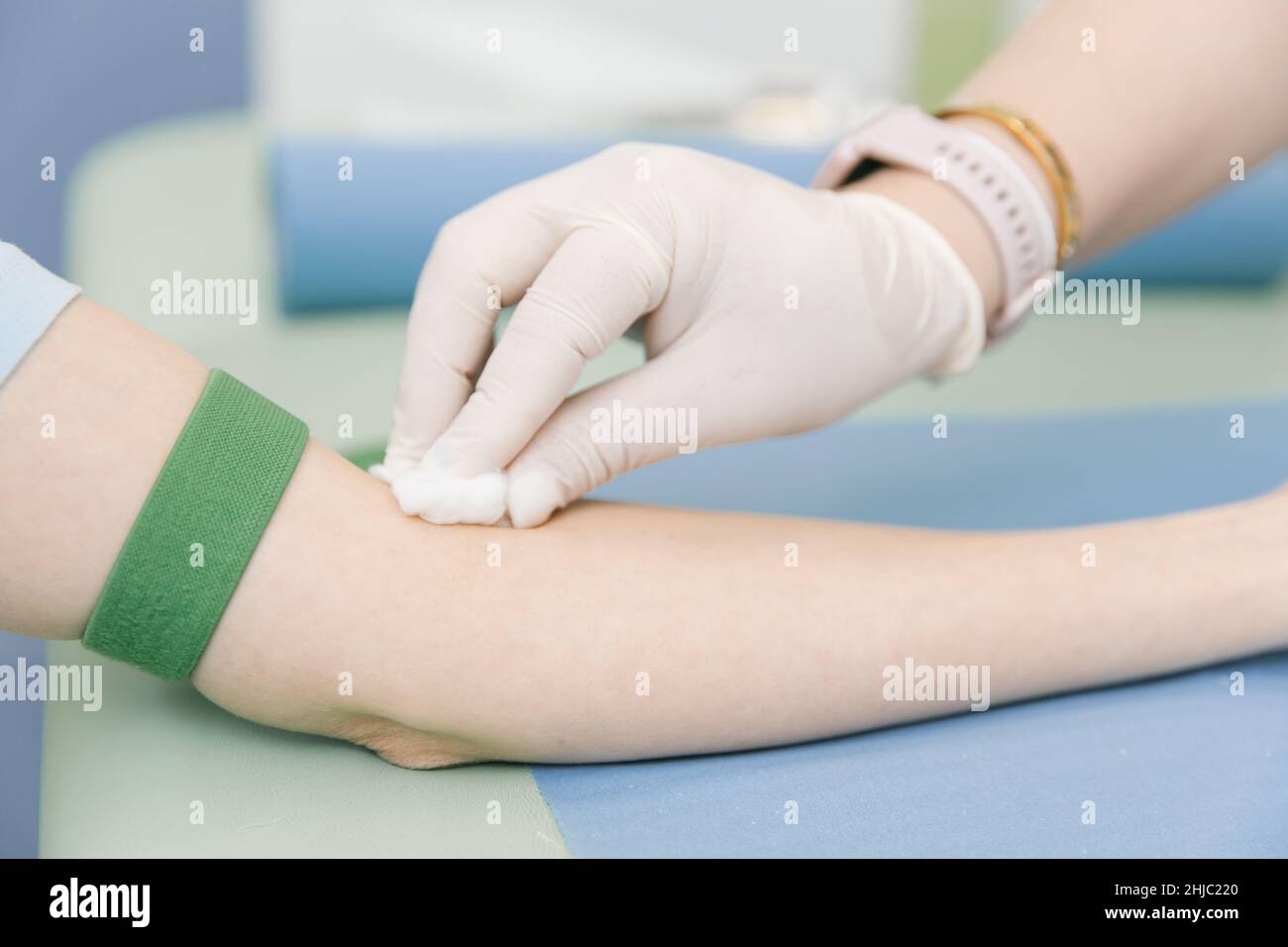Taking a blood test from a vein in the treatment room. Nurse pricking a ...