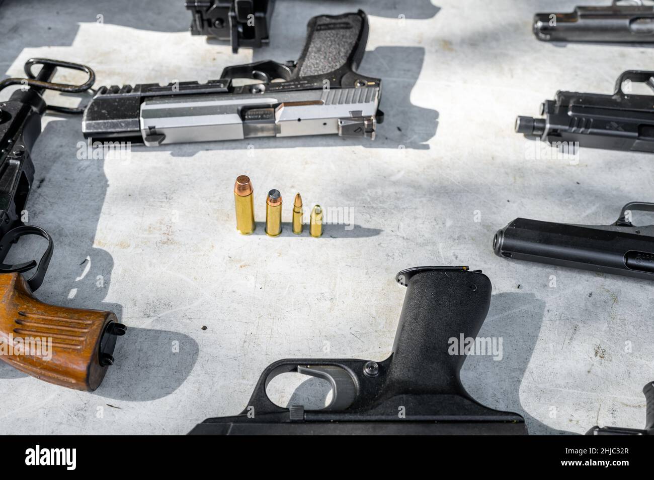 pistols from manufacturers around the world on the table, historical ...