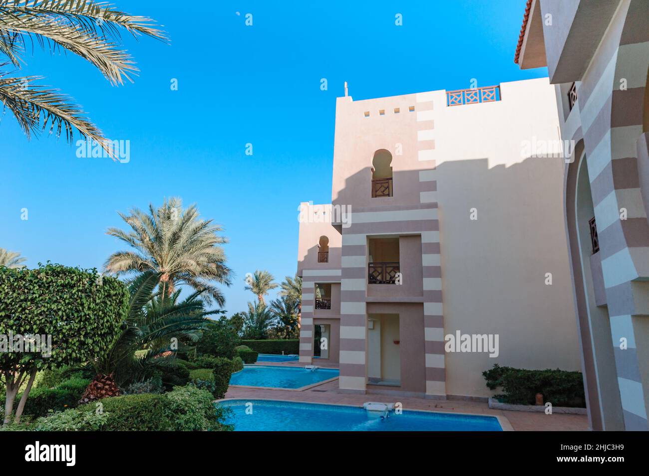 Beautiful swimming pool and palm trees in Egypt Stock Photo - Alamy