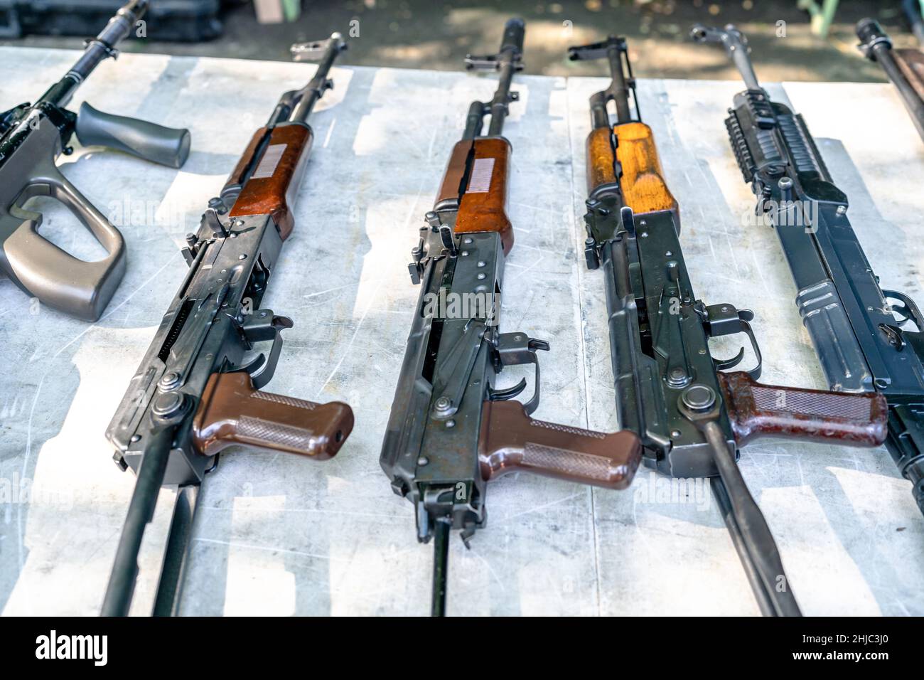 automatic weapons of various kinds on the table Stock Photo - Alamy