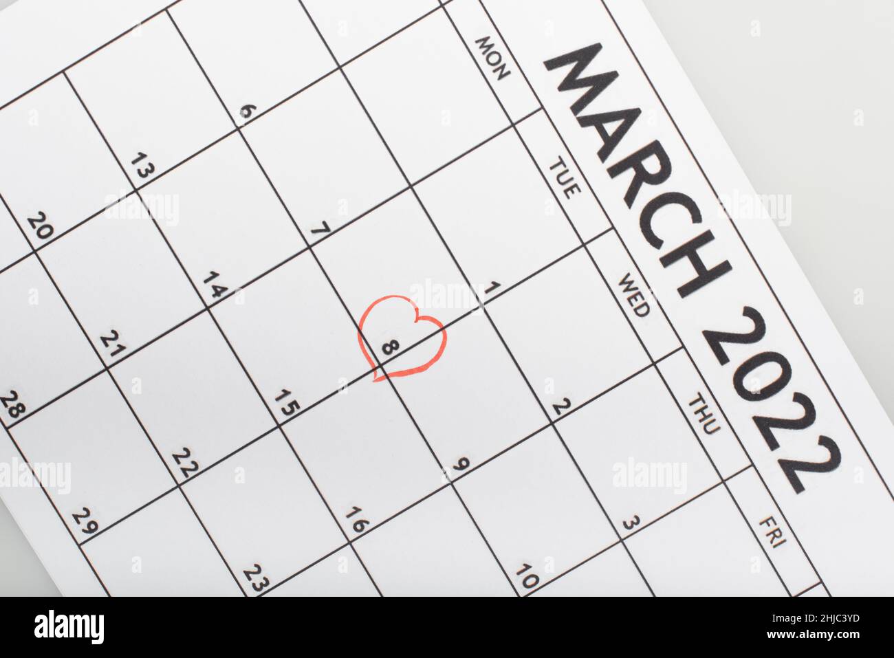 top view of march 2022 calendar with drawn heart around 8 march date ...