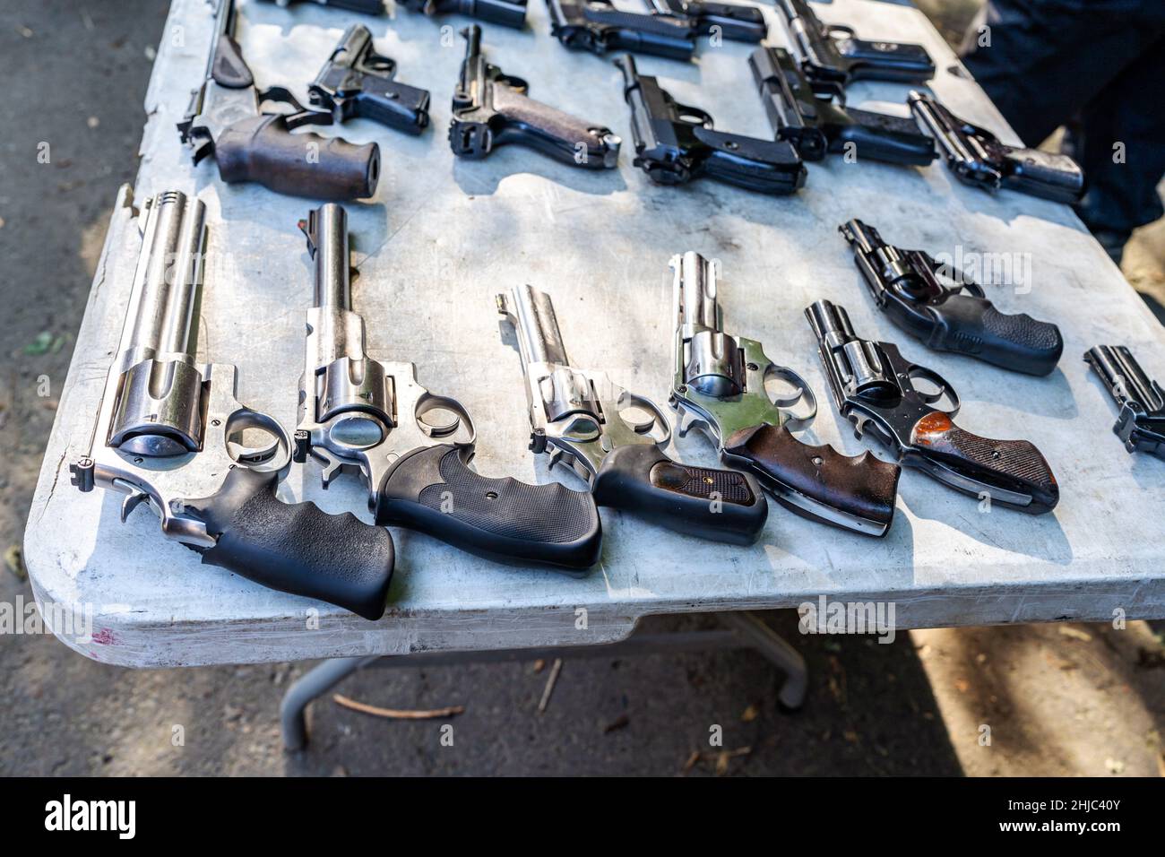 pistols from manufacturers around the world on the table, historical ...