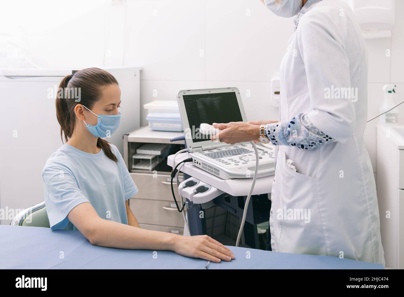 Doctor doing the ultrasound on the hand close up. Doctor demonstrates ...