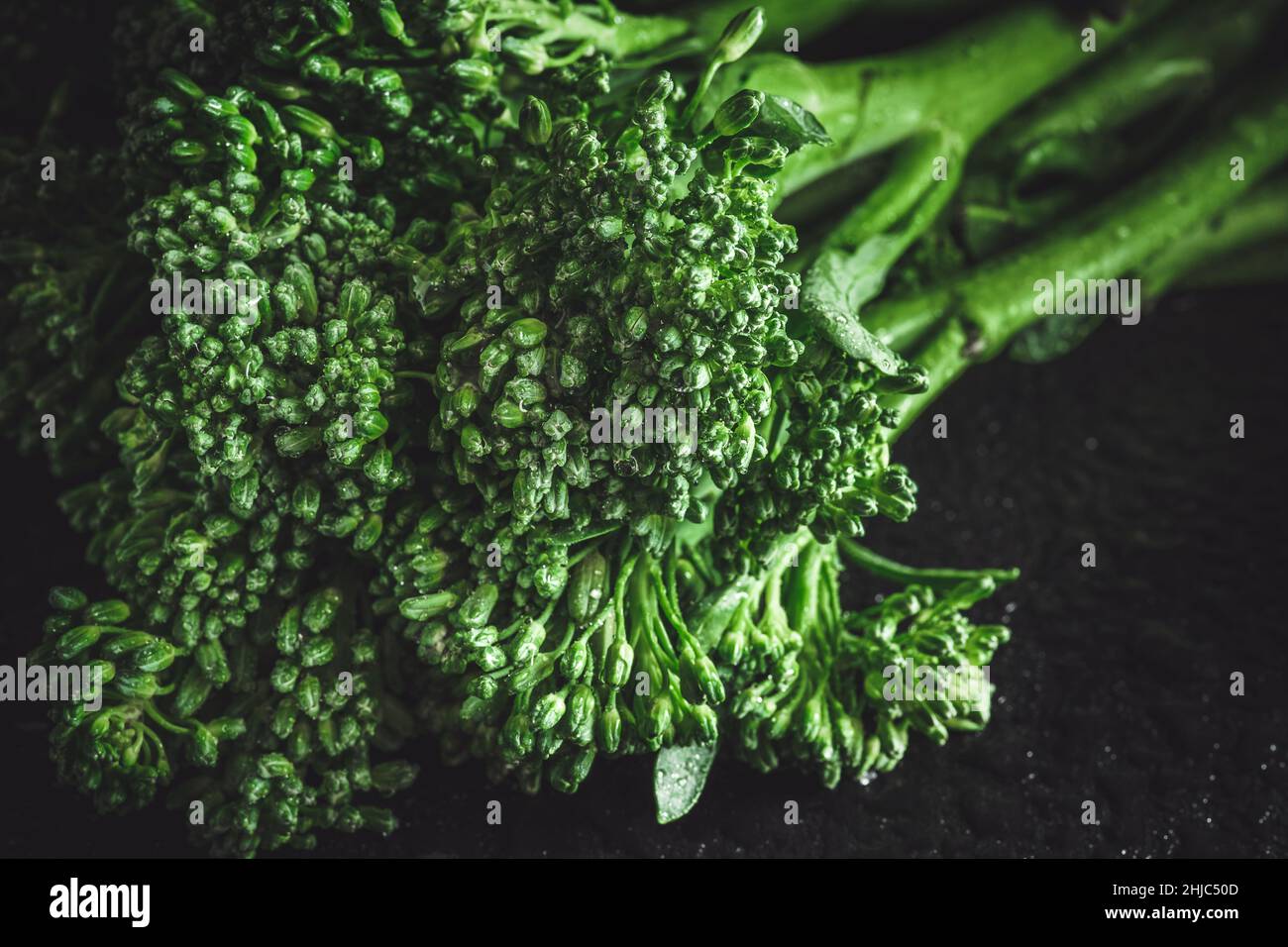 Fresh bimi vegetable on a dark table. Raw baby broccoli Stock Photo - Alamy