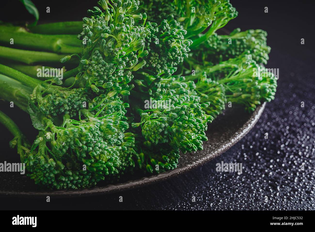 Fresh bimi vegetable on a dark table. Raw baby broccoli Stock Photo - Alamy