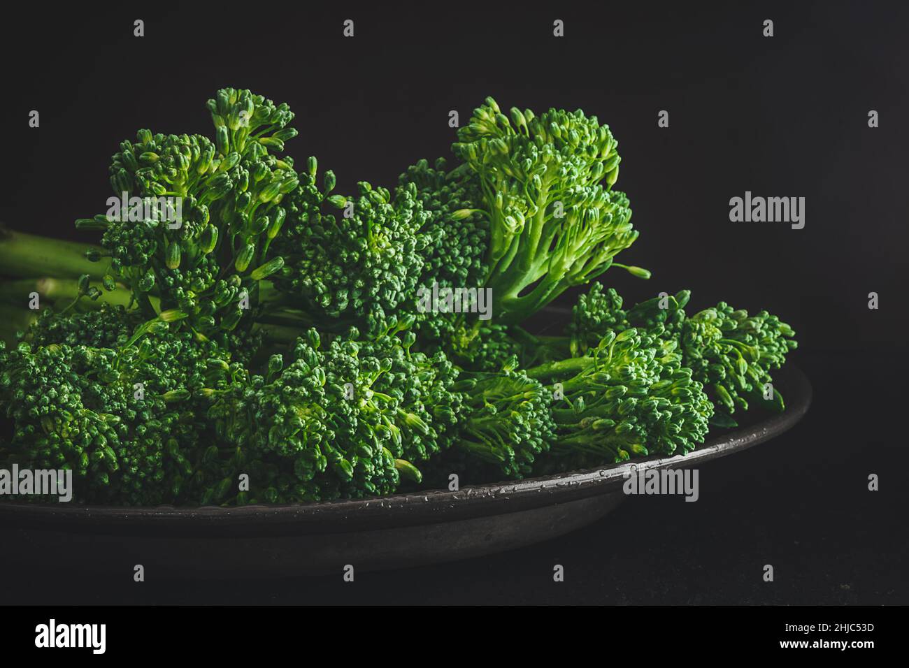 Fresh bimi vegetable on a dark table. Raw baby broccoli Stock Photo - Alamy