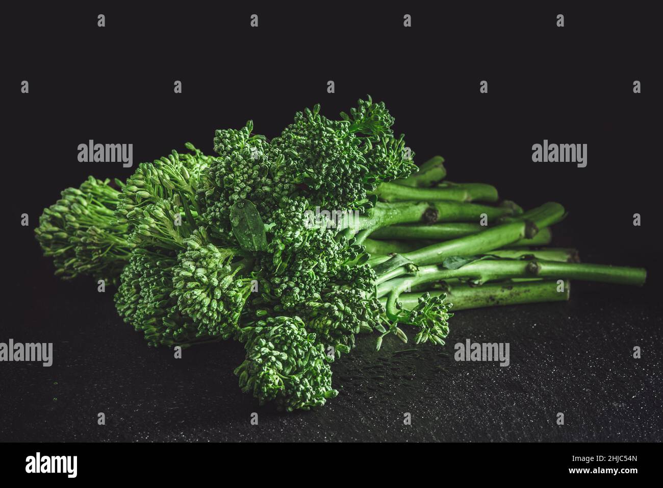 Fresh bimi vegetable on a dark table. Raw baby broccoli Stock Photo - Alamy