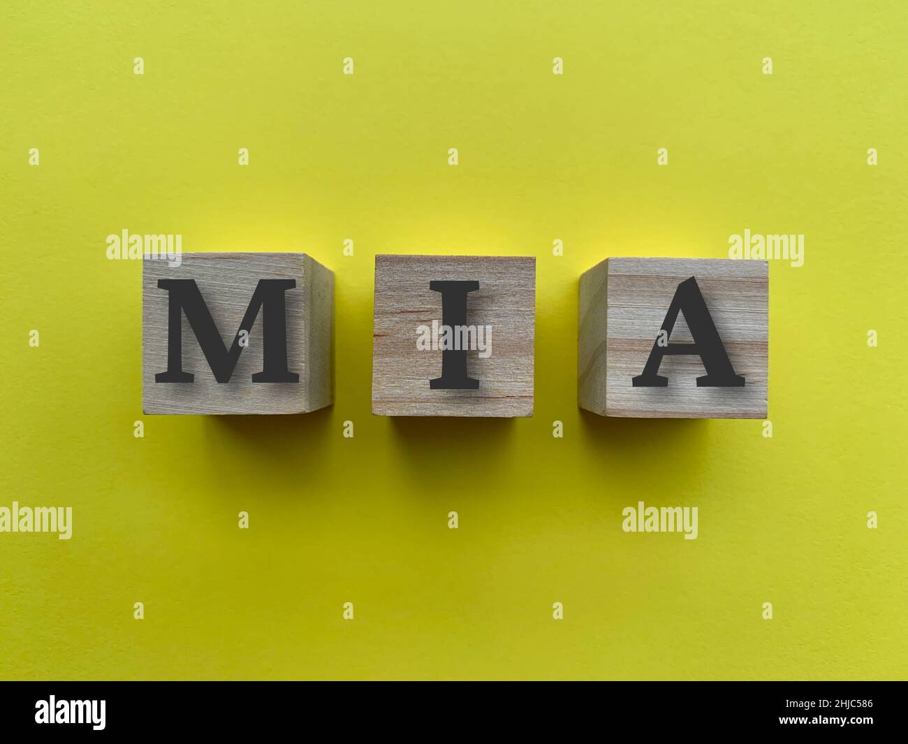 Alphabets of MIA on wooden blocks with yellow background Stock Photo ...