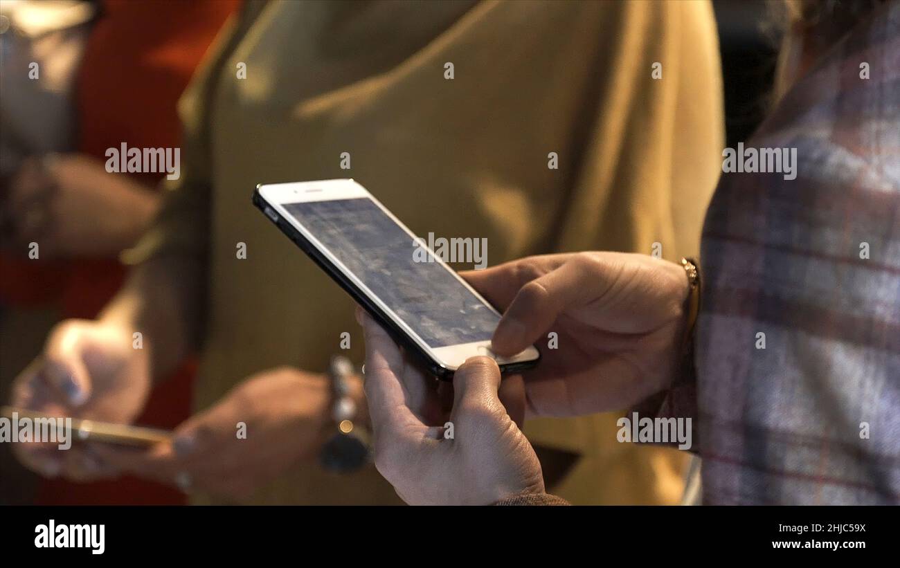 Close up for man hands using smart phone, raising the brightness level ...