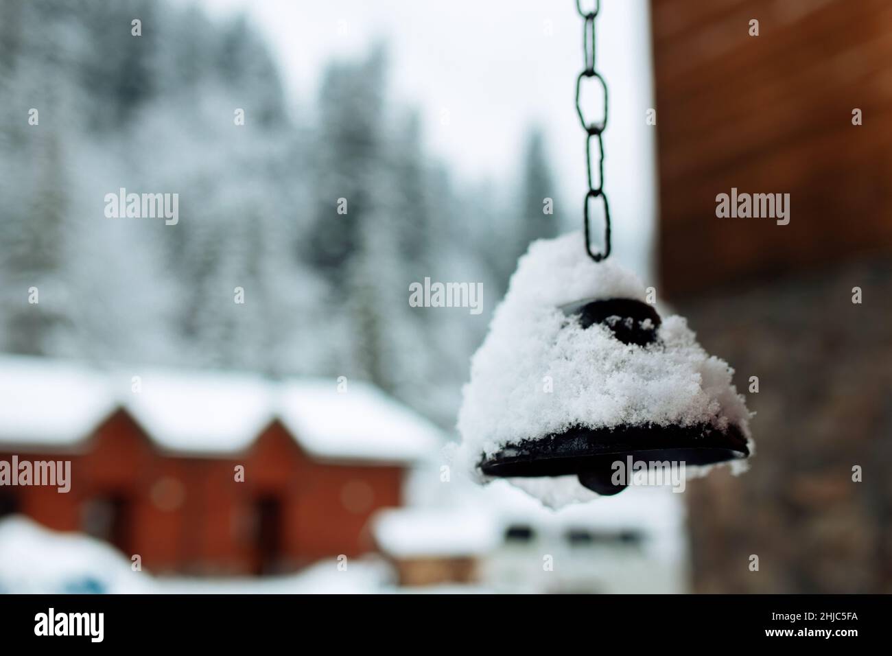 A decorative bell of snow falls on at the entrance to the building ...