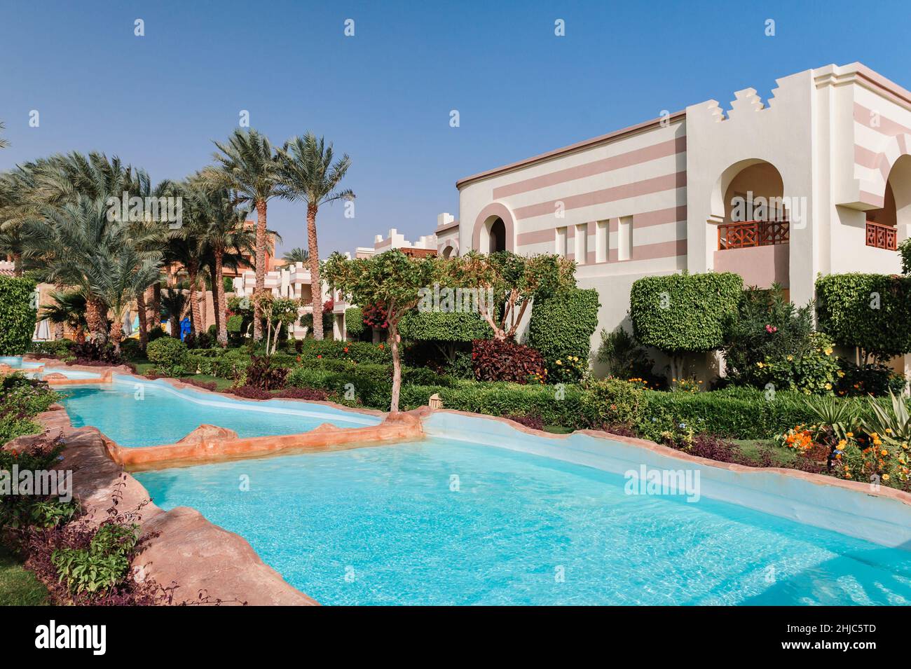 Beautiful swimming pool and palm trees in Egypt Stock Photo - Alamy