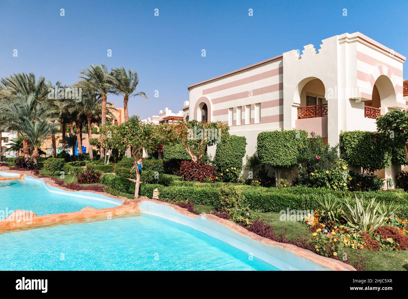 Beautiful swimming pool and palm trees in Egypt Stock Photo - Alamy