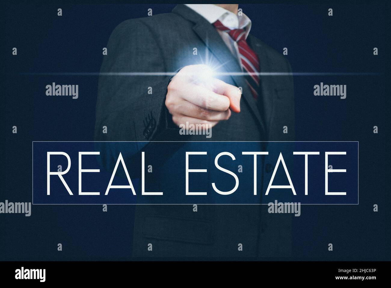 Real estate - lettering, businessman pointing finger Stock Photo - Alamy