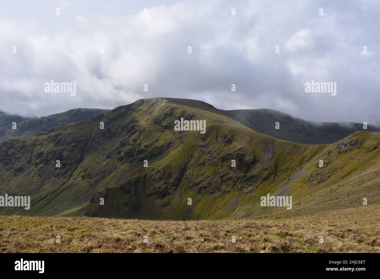 Haze, fog and clouds settling on top of a fell in England Stock Photo ...