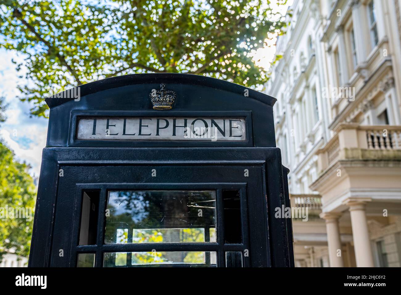 Vintage style british telephone booth next to city building Stock Photo ...