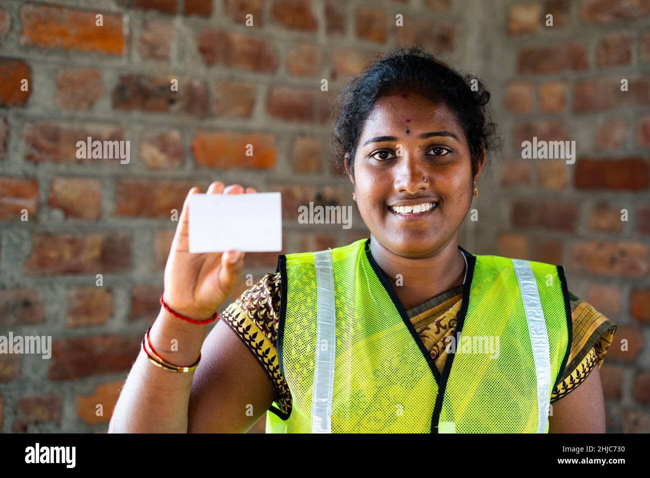 Indian happy smiling labour women showing empty card by lookig at ...