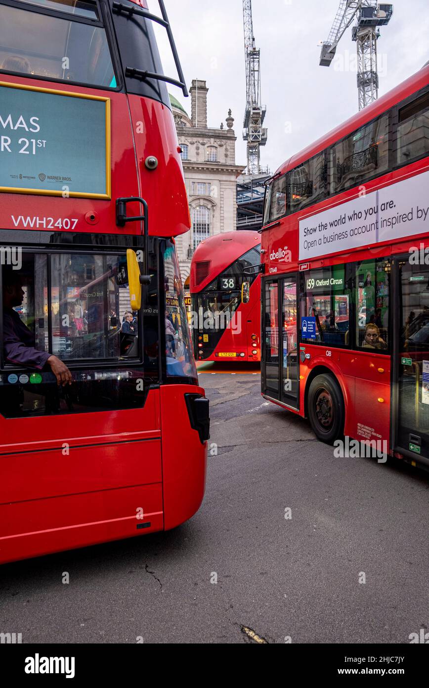 Red classic double decker buses on city road with passengers onboard ...