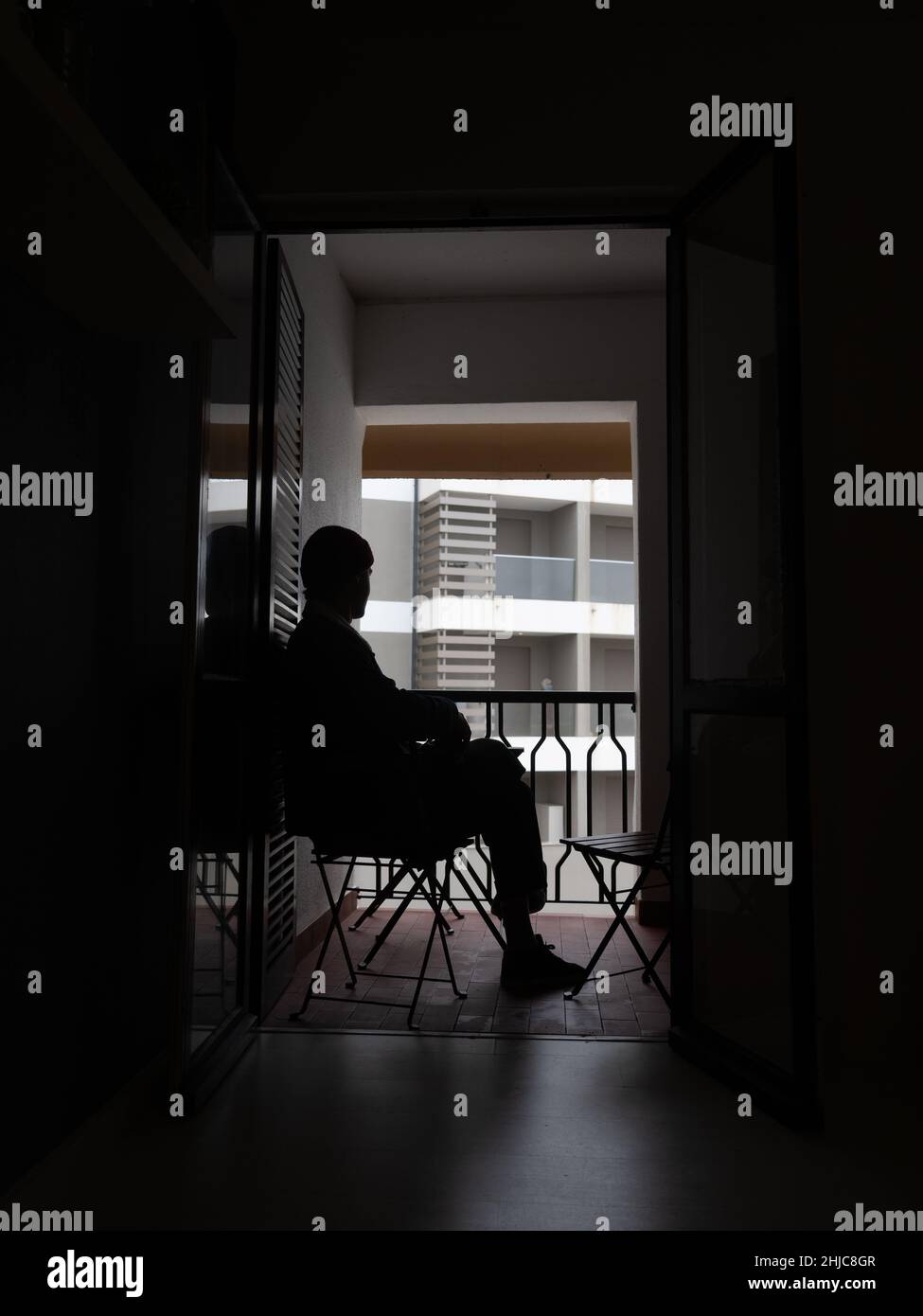 People sitting on balcony hi-res stock photography and images - Alamy