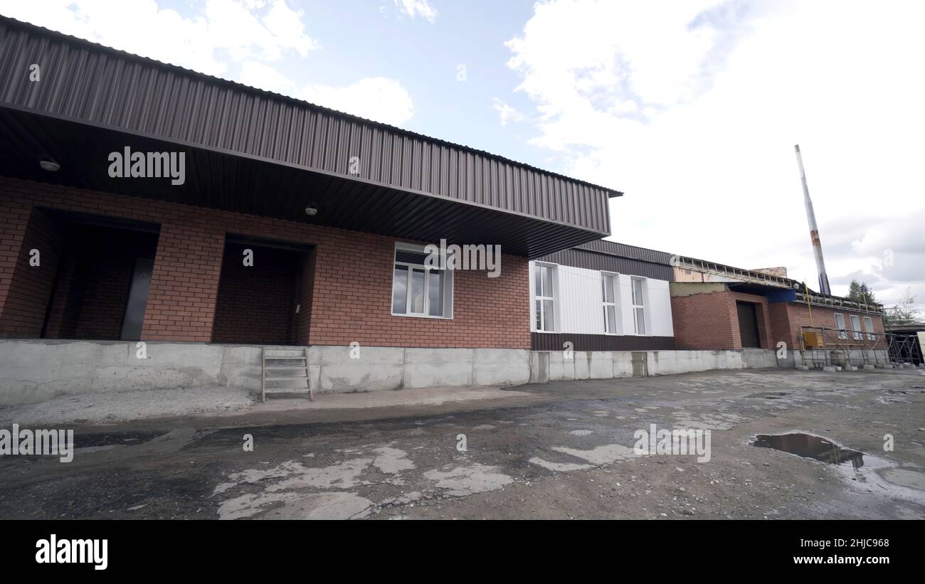 View of exterior of small factory. Action. Facade of old building of ...