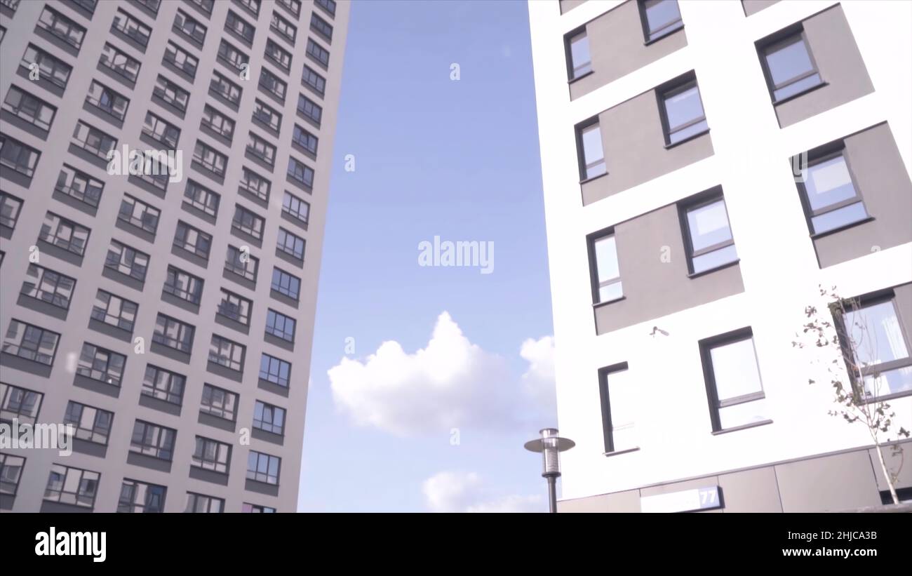 Bottom view of residential buildings with blue sky. Frame. Bottom view ...
