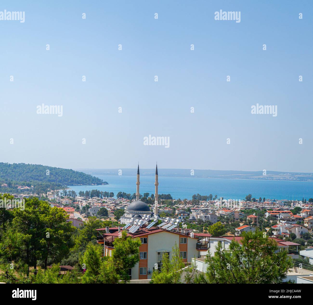 View of Akbuk village in Turkey. Cottage houses and a mosque with ...