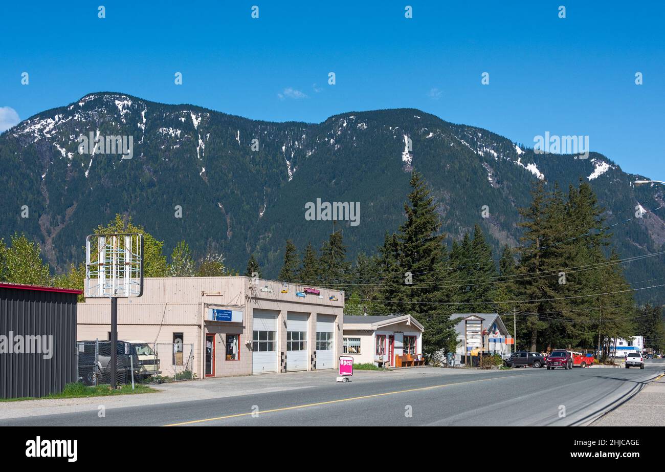 Street of small canadian town on snow mountain and blue sky background ...