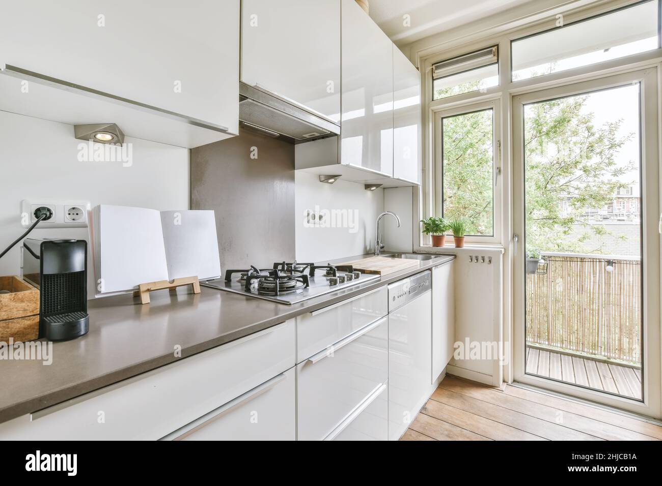 Long brown countertop with white kitchen set in a delightful kitchen ...