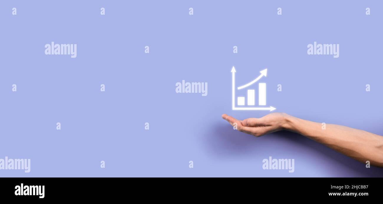 Businessman man holding a graph with positive profits growth. plan ...
